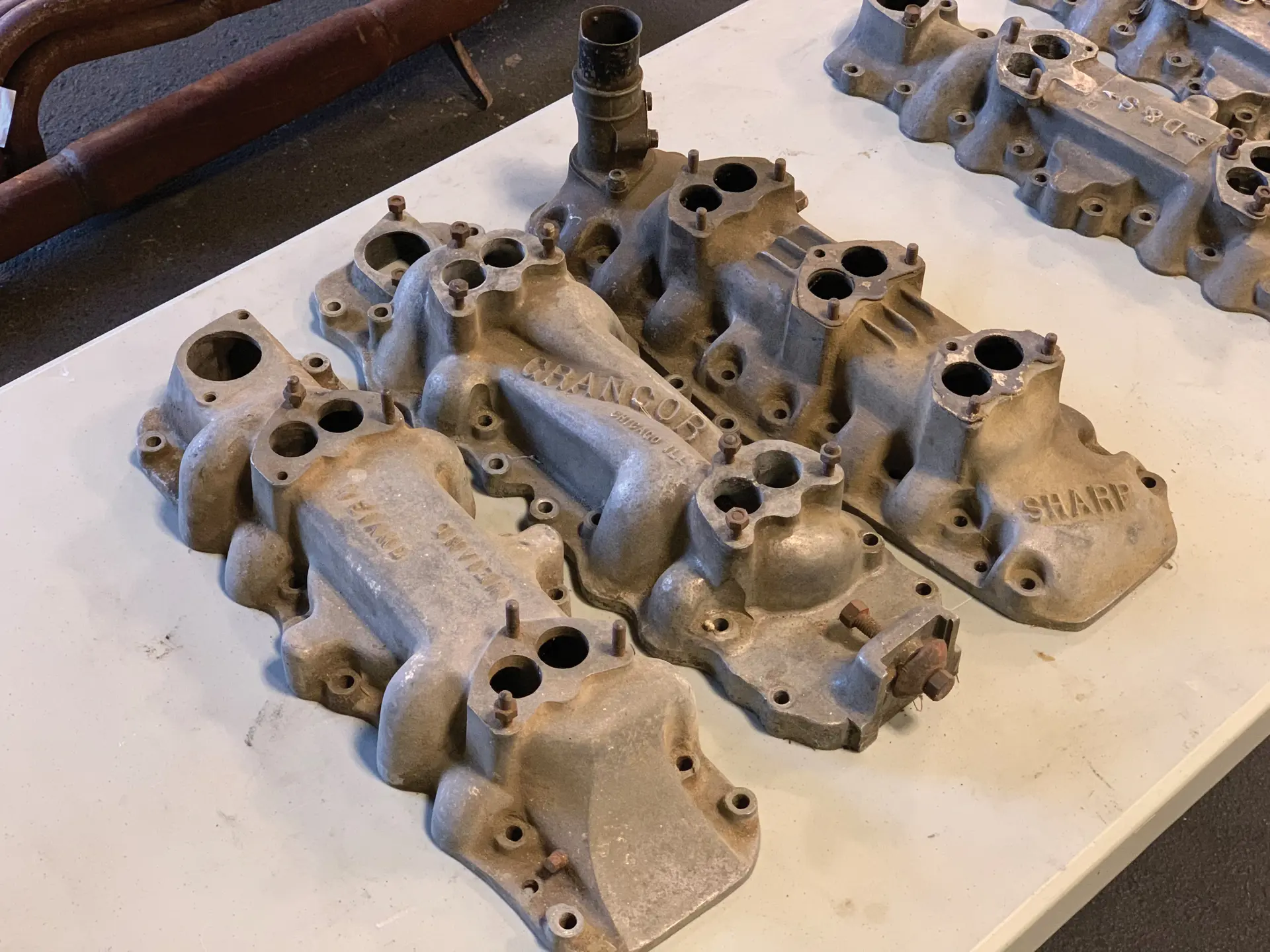 Set of 3 Flathead Ford Intake Manifolds Including Grancor, Sharp, and ...