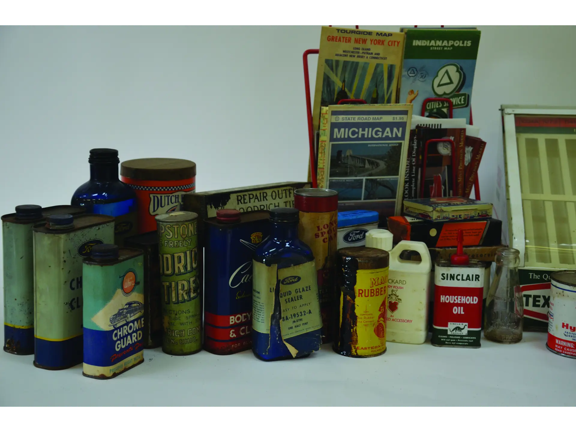 A group of collectible automotive manufacturing tins. bottles, cans ...