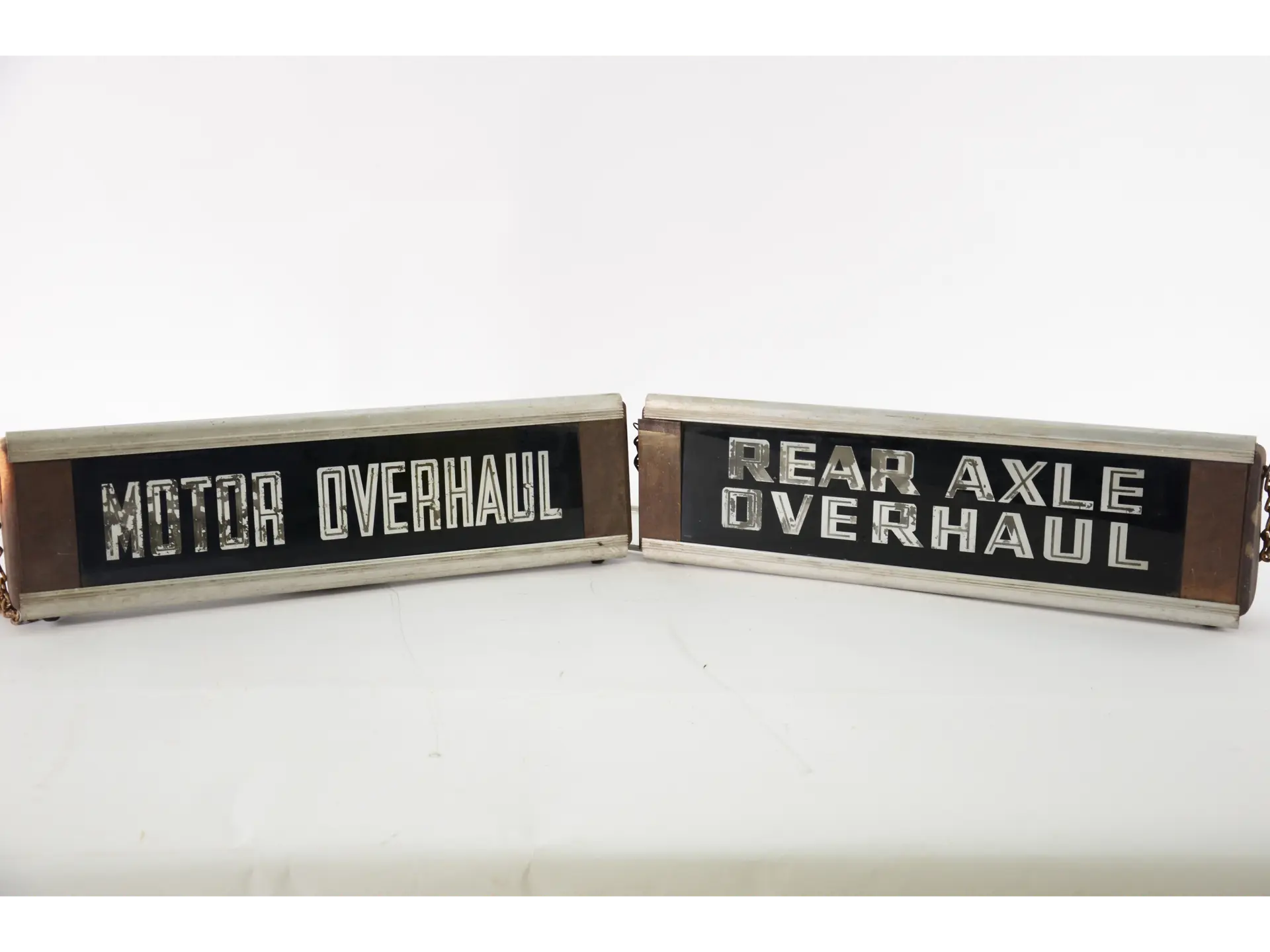 Two vintage shop signs. One reads 'Motor Overhaul' and the other reads ...