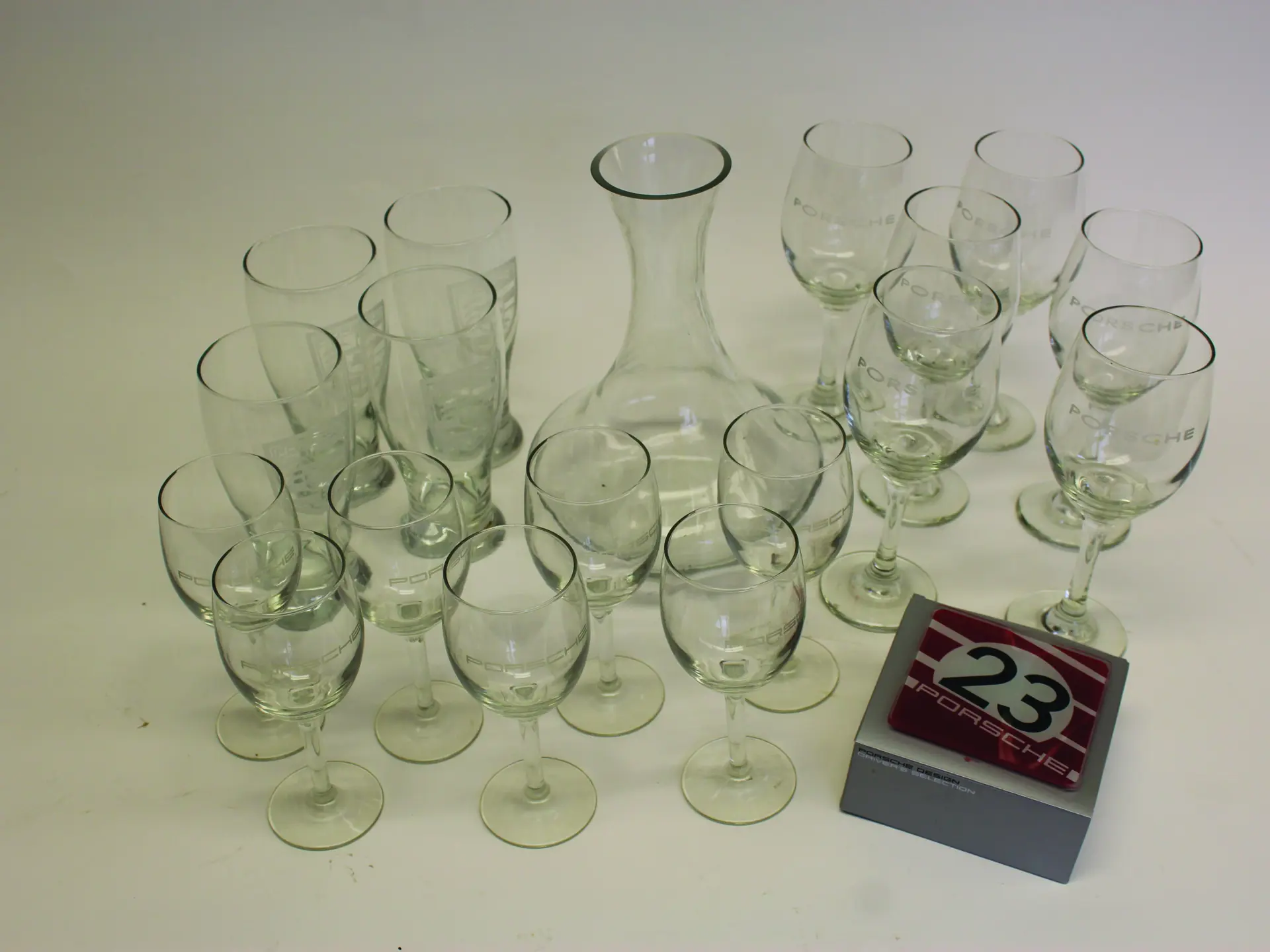 An assortment of Porsche branded glassware and Porsche Design, Le Mans ...