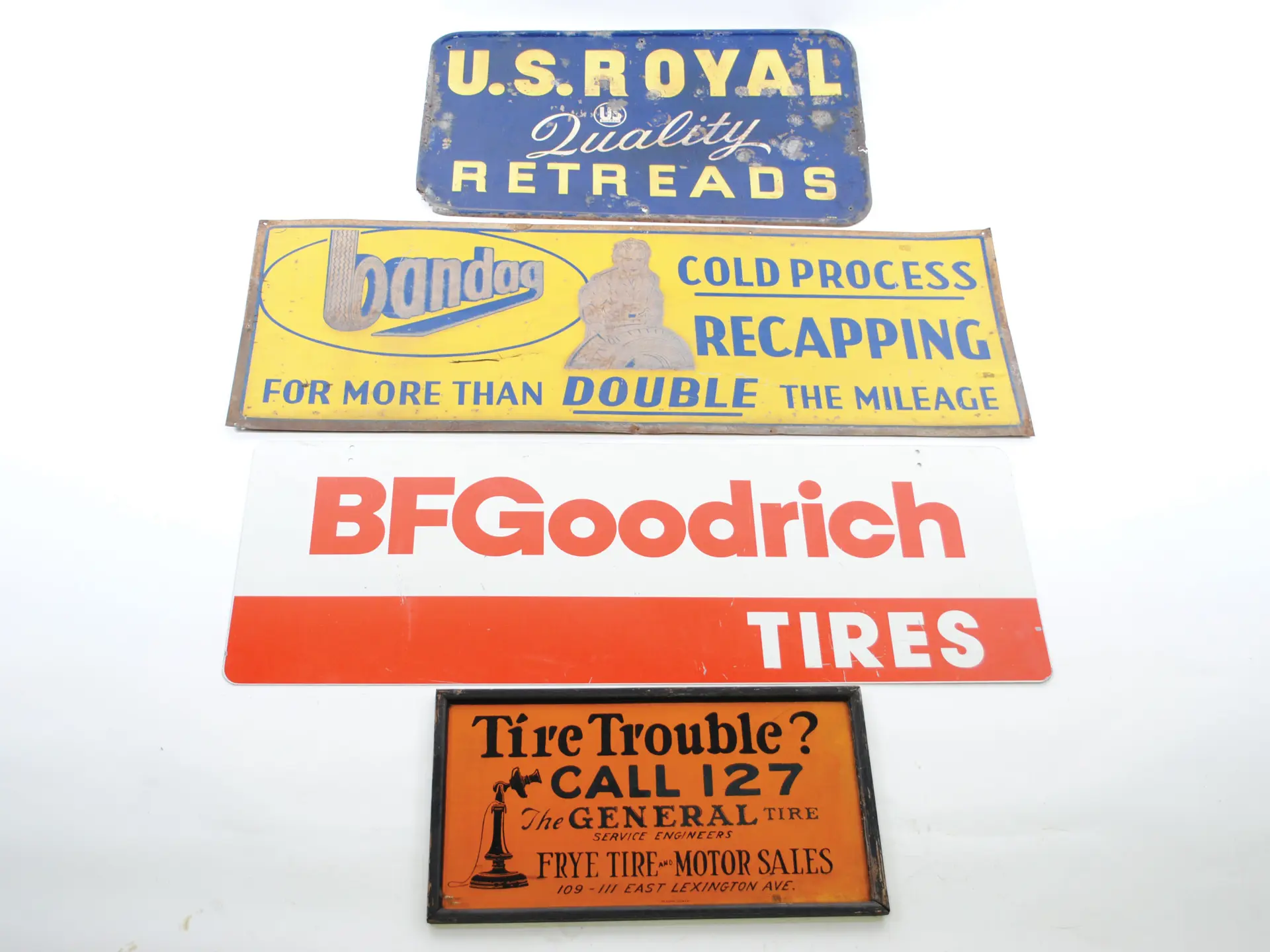 A grouping of tin painted tire signs | Auburn Spring 2016 | RM Sotheby's