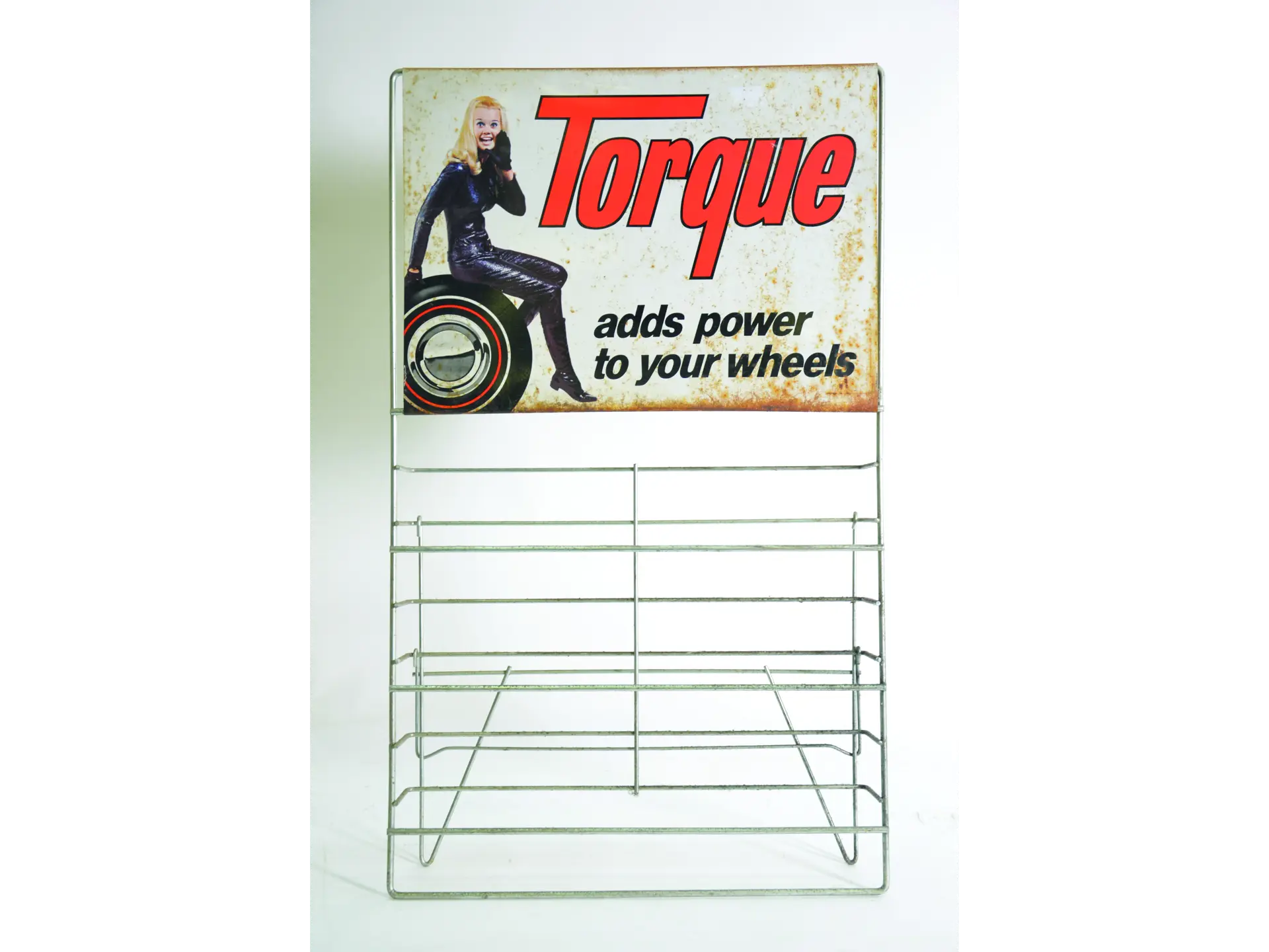 A single-sided, tin painted “Torque ads power to your wheels” display ...