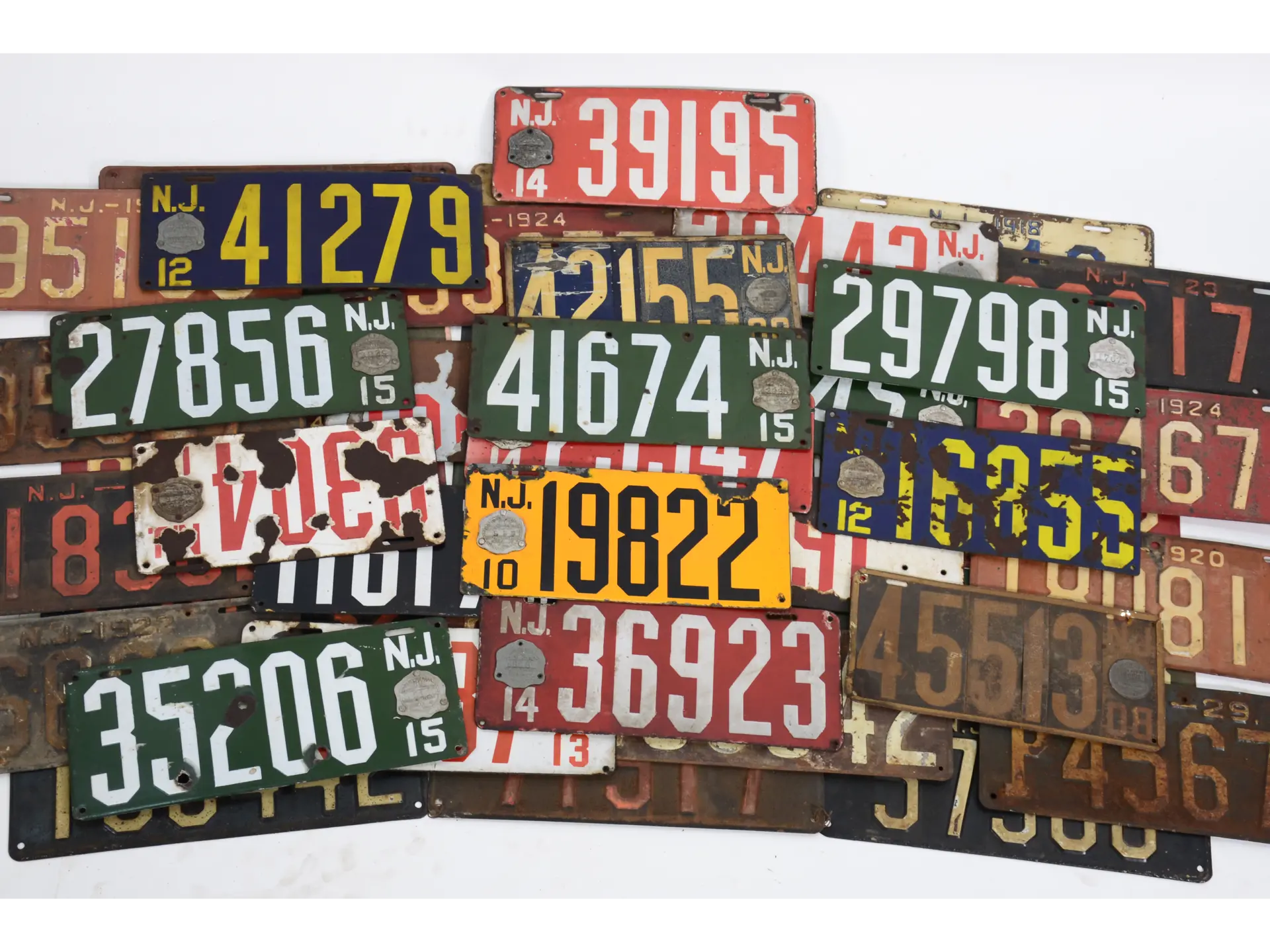 A large grouped assortment of NJ license plates starting with 1908, (43 ...