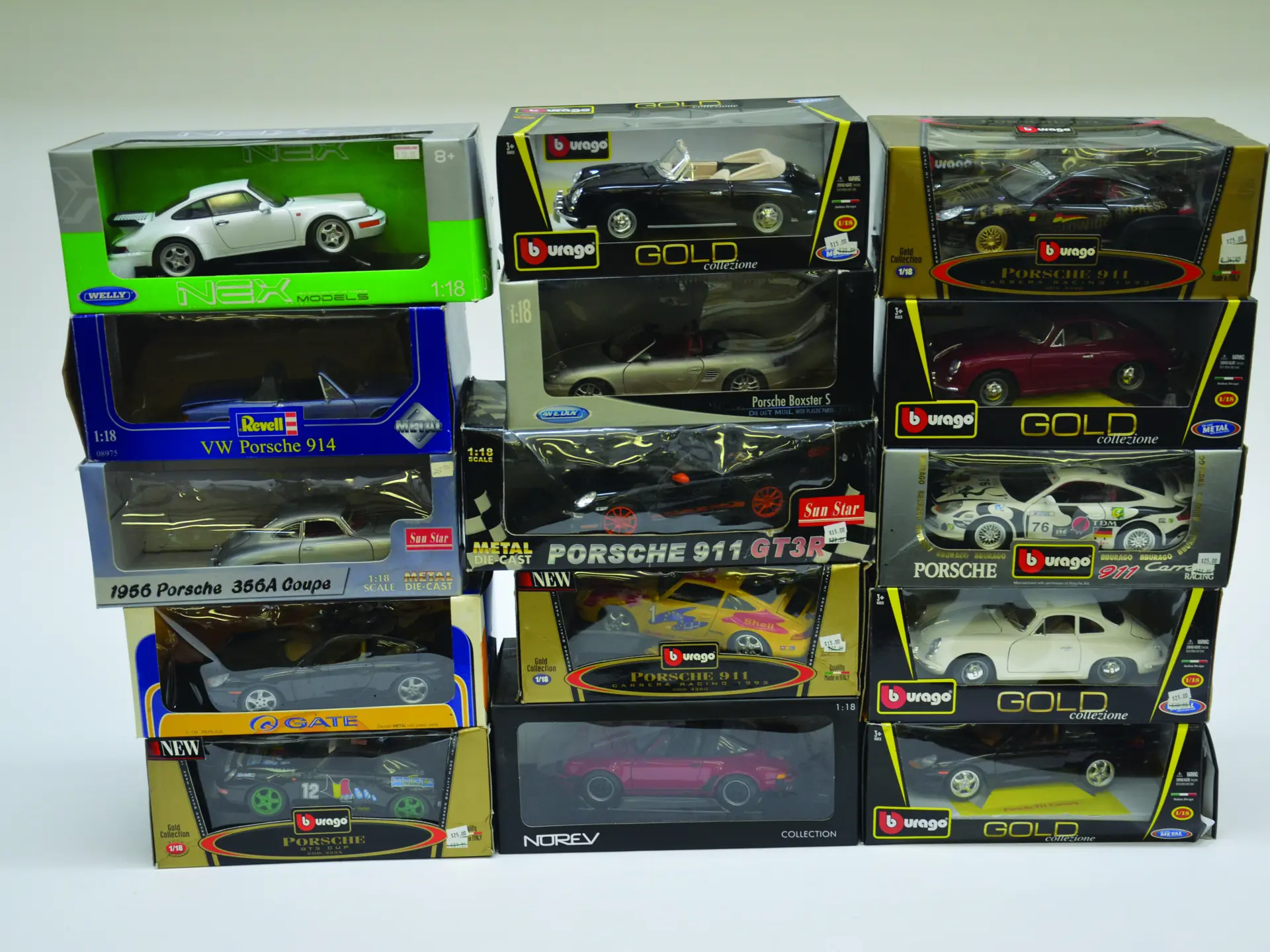15 boxed 1/18 scale Porsche models various years colors and makes ...