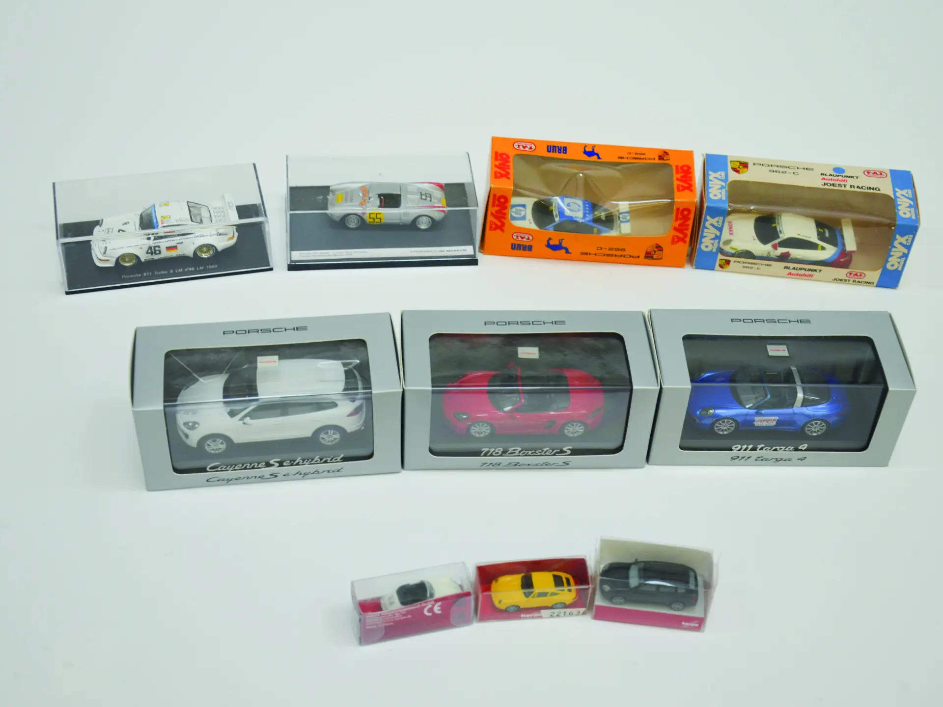 A grouping of mostly 1/43 scale Porsche boxed models together with ...