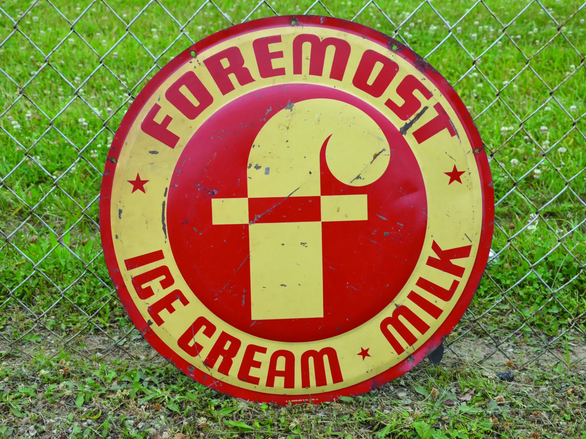 A single-sided, tin painted ‘Foremost ice cream’ sign 24” diameter ...