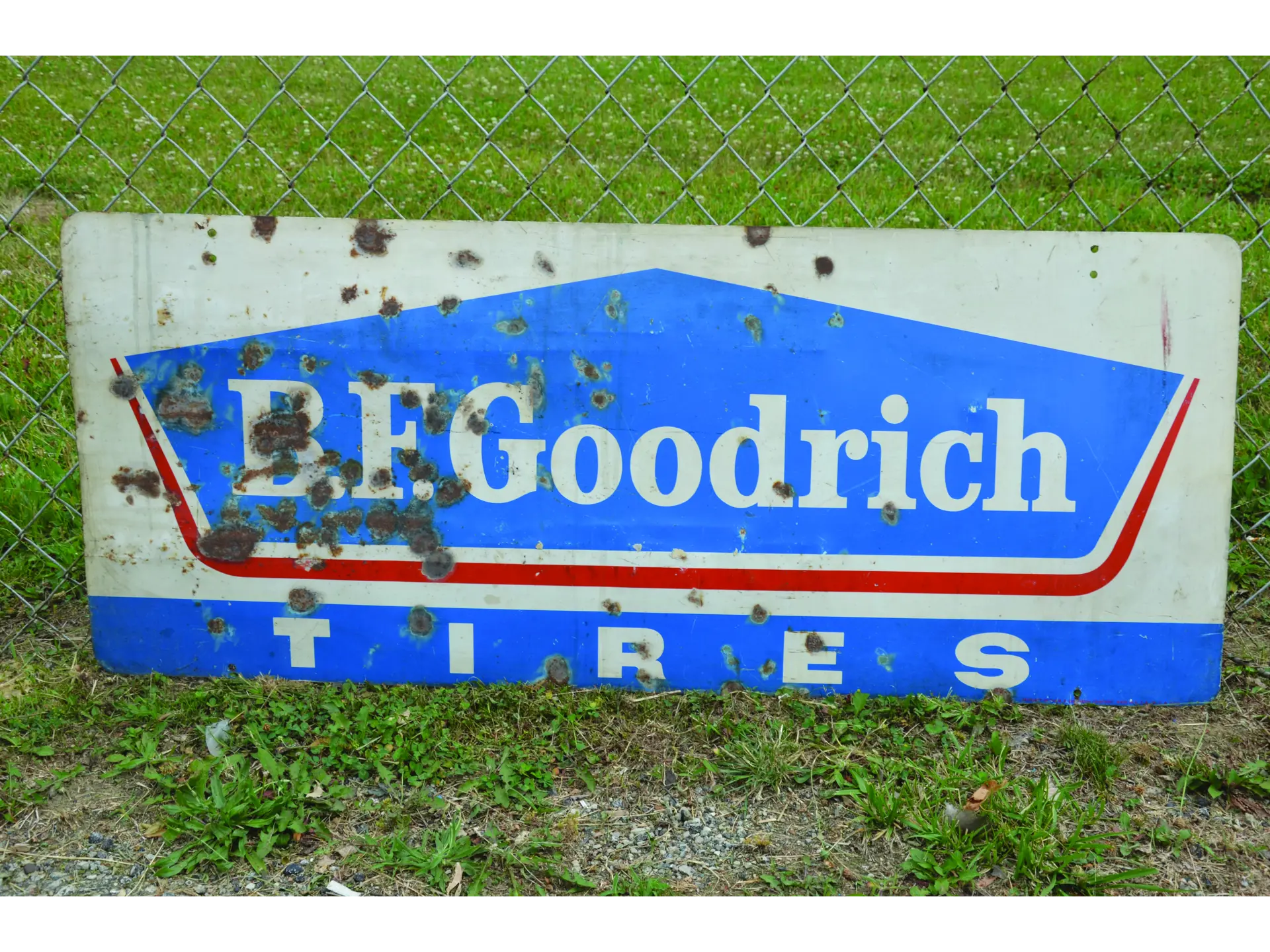 A double-sided, tin painted ‘BFGoodrich tires’ sign, 48” x 20 ...