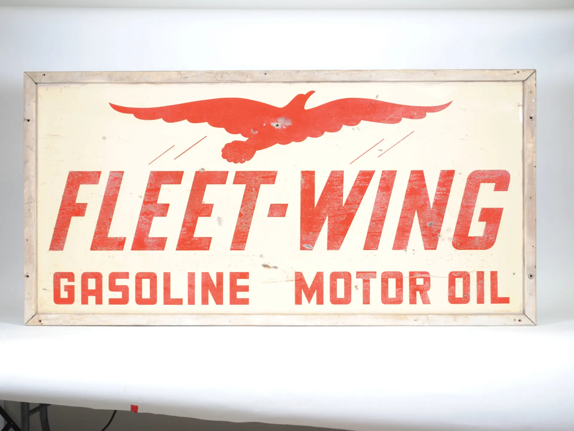 A self-framed tin painted fleet wing gasoline motor oil sign 72" x 36 ...