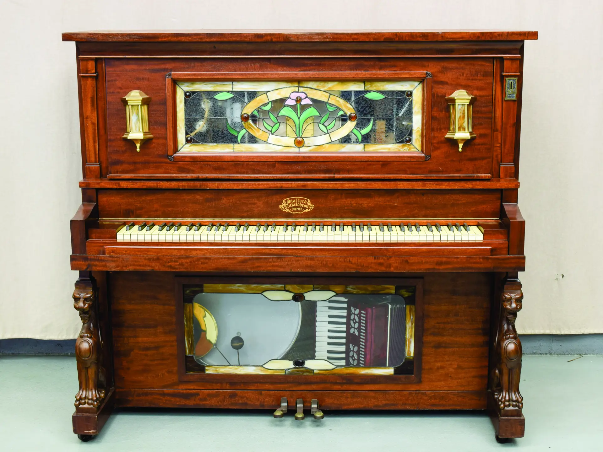 A Stafford nickelodeon player piano, 64 inches wide, 55.5 inches tall ...