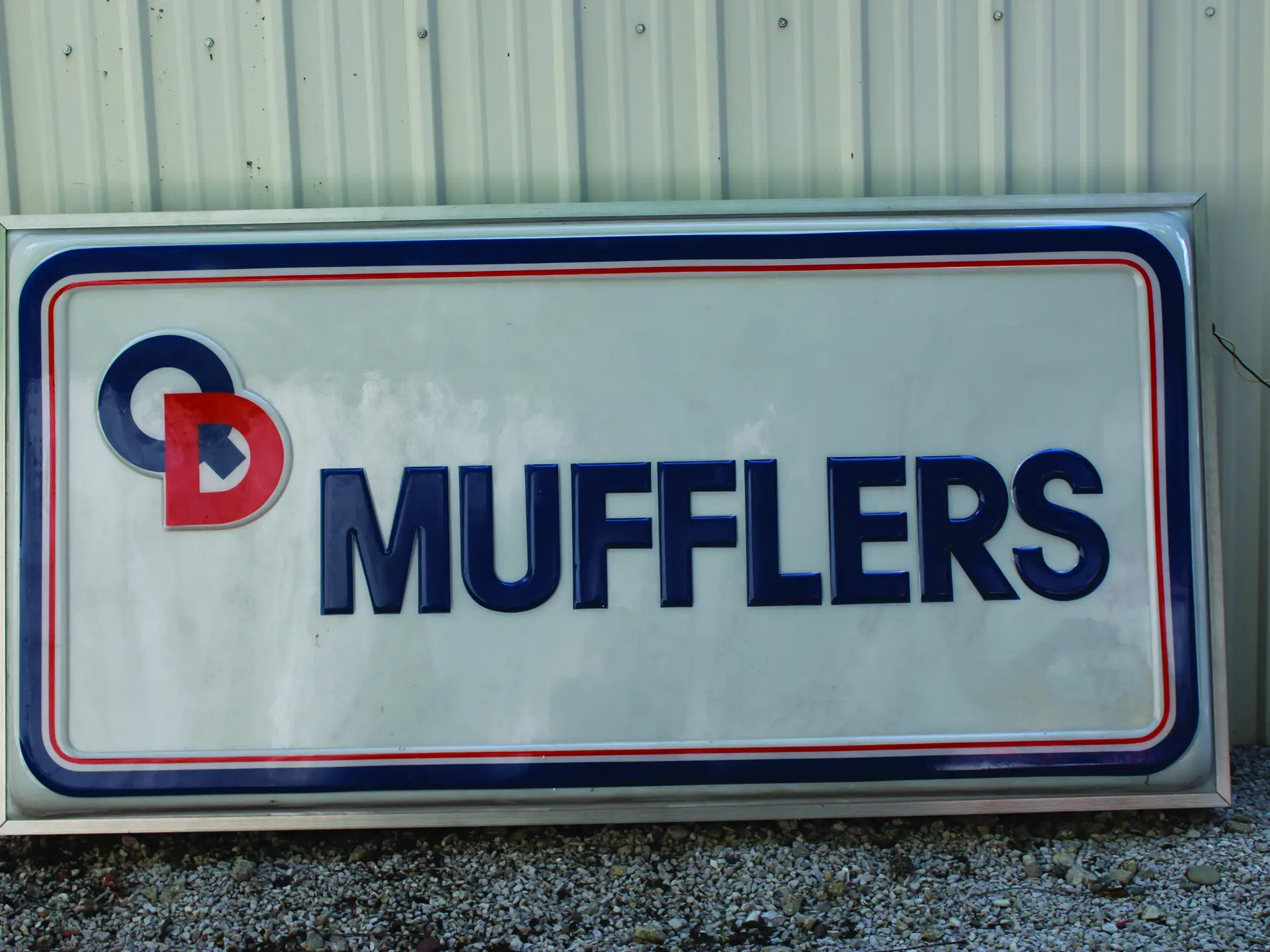 A large, double sided, QD mufflers sign | Auburn Fall 2017 | RM Sotheby's