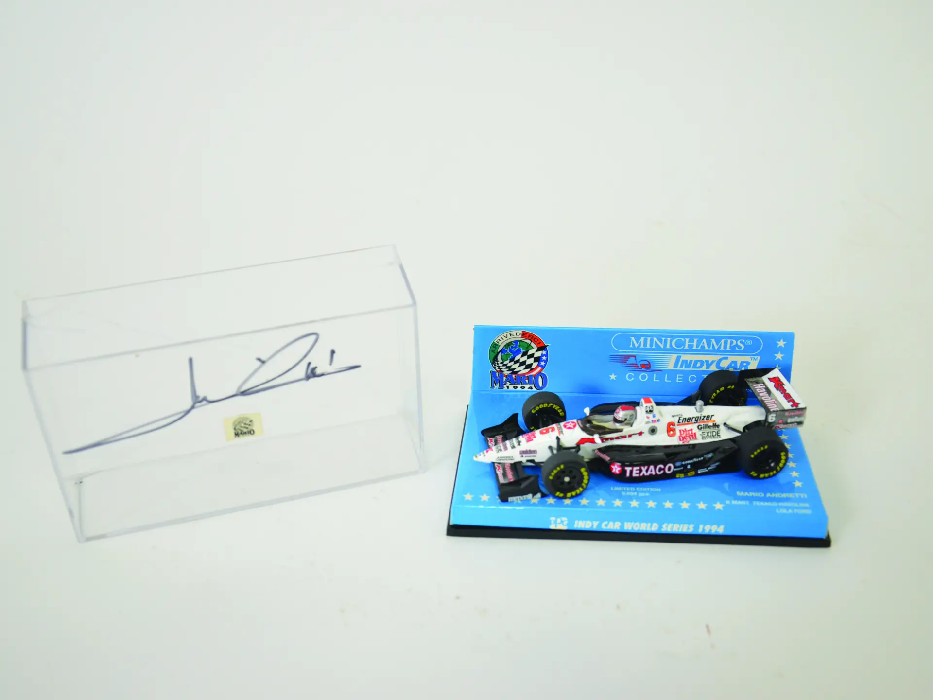 A 1/43 scale mini Champs IndyCar, autographed by Mario Andretti ...